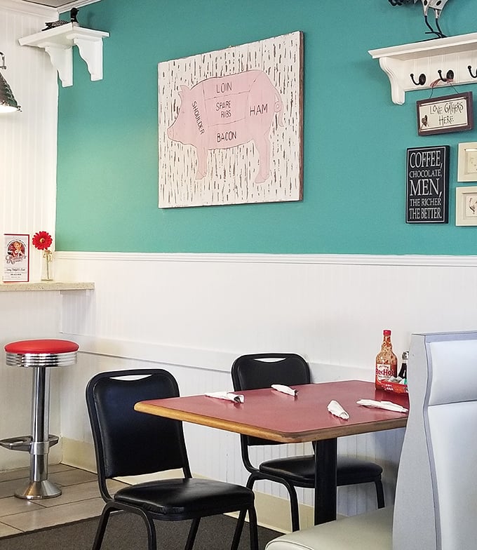 Turquoise walls and whimsical decor create the perfect backdrop for serious eating. Notice nobody's looking at their phones—the food demands full attention.