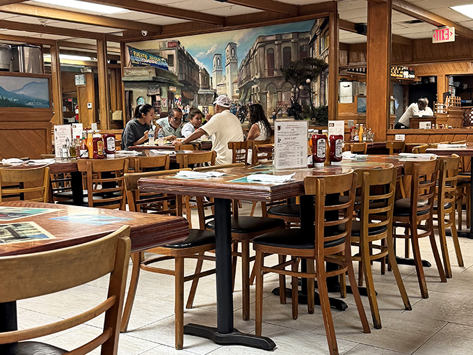 The dining room buzzes with conversation in multiple languages, all translating roughly to "Have you tried the Cuban sandwich yet?"