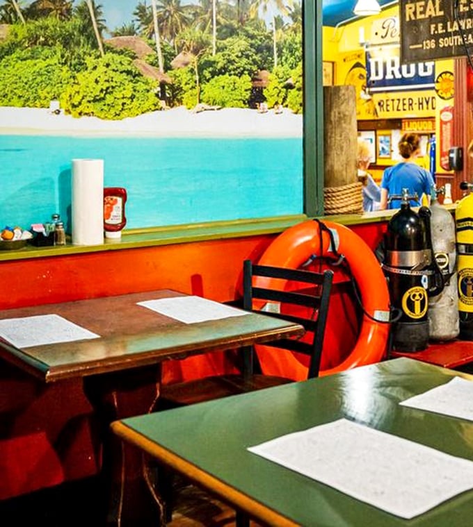 Dining with a view! This corner booth offers tropical vistas alongside diving gear&mdash;because why shouldn't Ohio diners pretend they're oceanside?
