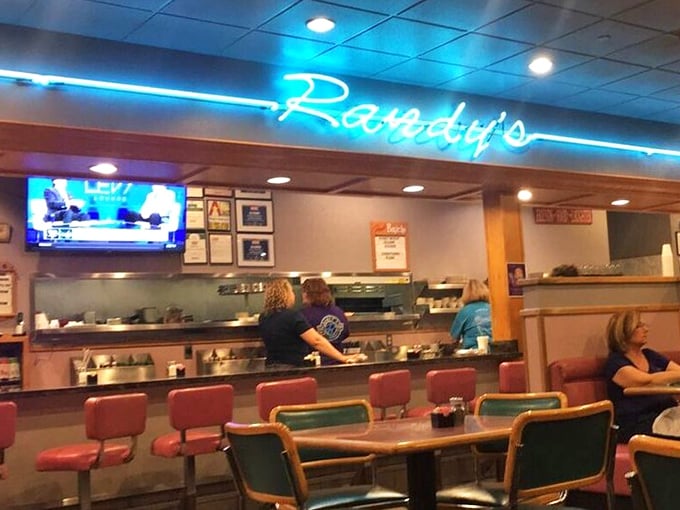 The bustling counter area showcases the restaurant's heart—where regulars perch on red vinyl stools and staff move with the practiced efficiency of Broadway dancers.