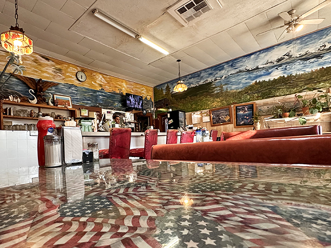 American flags and landscape murals create a patriotic panorama, turning a simple meal into a celebration of roadside Americana.