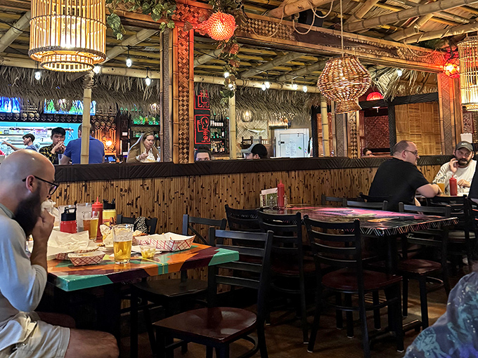 The tiki-inspired interior feels like you've stumbled into the coolest basement rec room from 1972, complete with bamboo accents and conversation-starting decor.