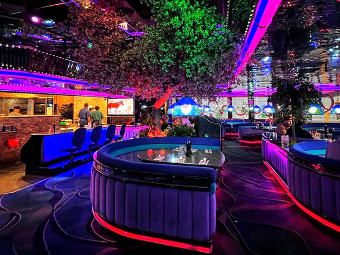 Vegas nightlife distilled to its essence: neon, plush seating, and the promise that whatever happens here stays here, especially in those circular booths.
