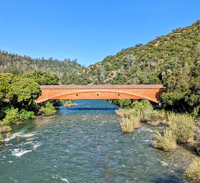 The bridge creates a perfect reflection in the clear waters below. Mother Nature and human ingenuity in perfect harmony.