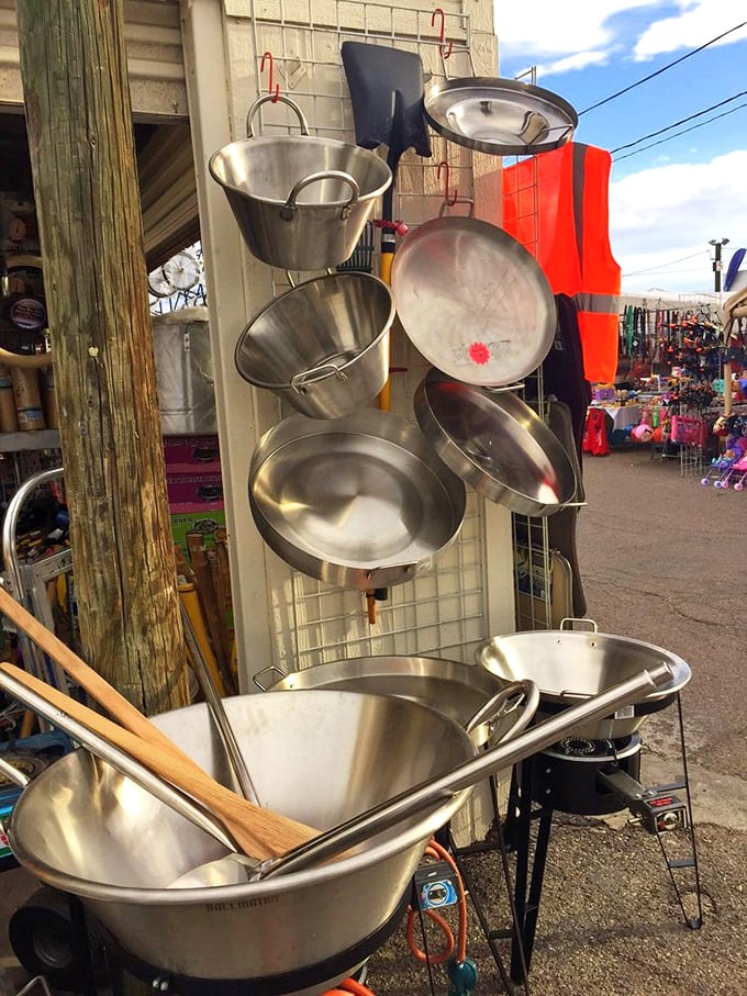 Professional-grade cooking vessels hanging like culinary wind chimes, waiting to transform someone's kitchen game.