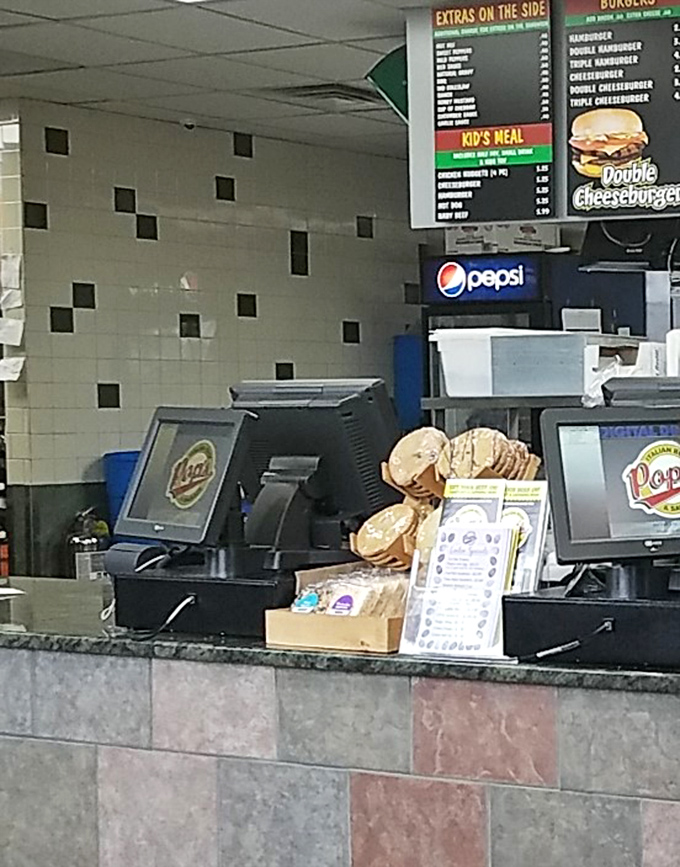 Behind the counter where sandwich magic happens. The assembly line of deliciousness operates with military precision.