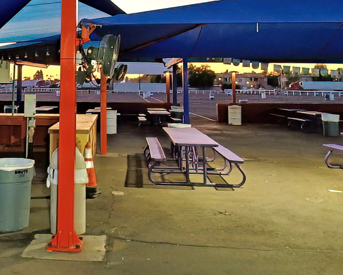 Covered picnic tables offer refuge from the Arizona sun for early arrivals. The best conversations happen in these in-between spaces.