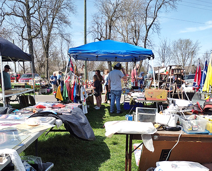 A sea of possibilities under blue canopies. Early birds get first pick while latecomers might snag better deals as vendors prepare for the journey home.