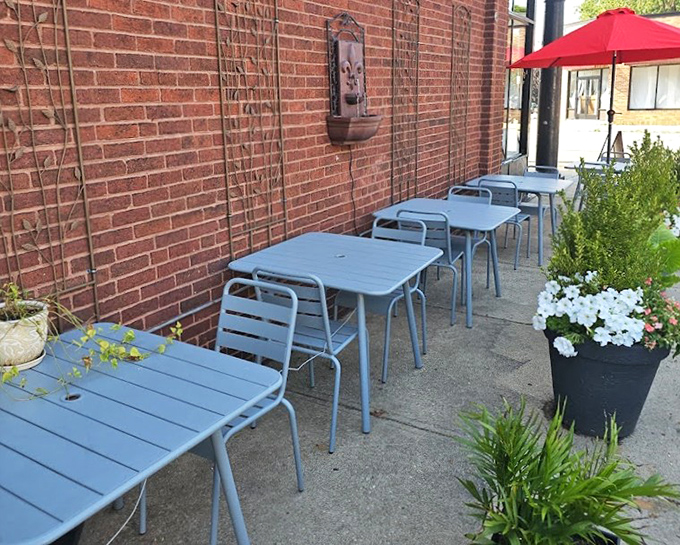 Blue tables line the brick exterior, offering al fresco dining that feels like a little slice of European sidewalk caf&eacute; culture in Lakewood.