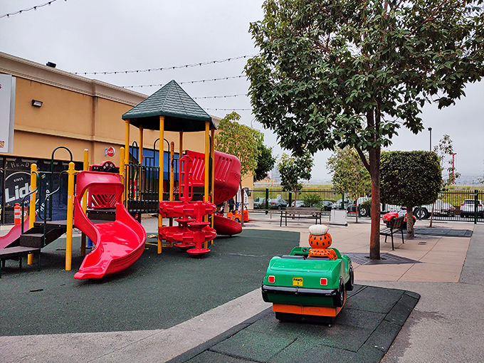 The playground oasis: where smart parents recharge their shopping stamina by letting little ones burn energy between store marathons.