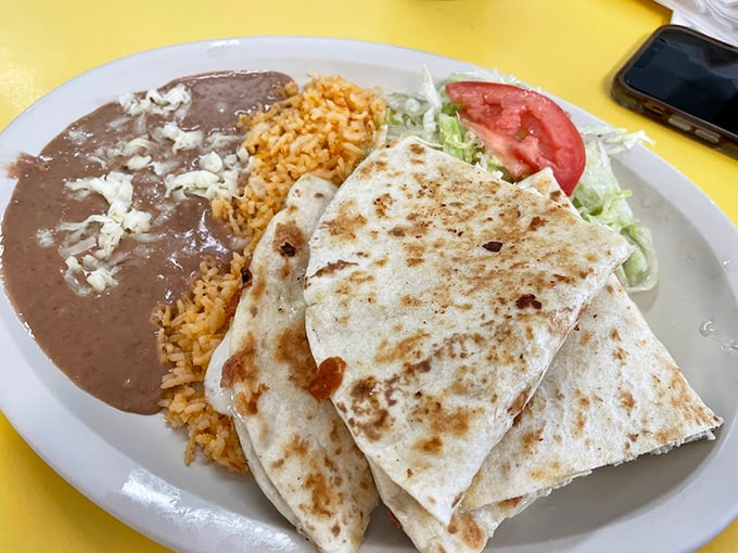 A quesadilla plate that doesn't just feed you but respects you, flanked by rice and beans that refuse to be mere side characters.