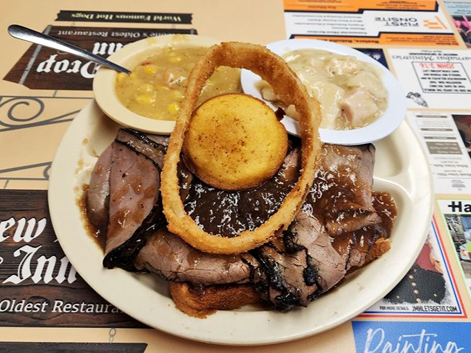 Roast beef platter with gravy, onion rings, and sides transforms a simple lunch into a celebration worthy of unbuckling your belt.
