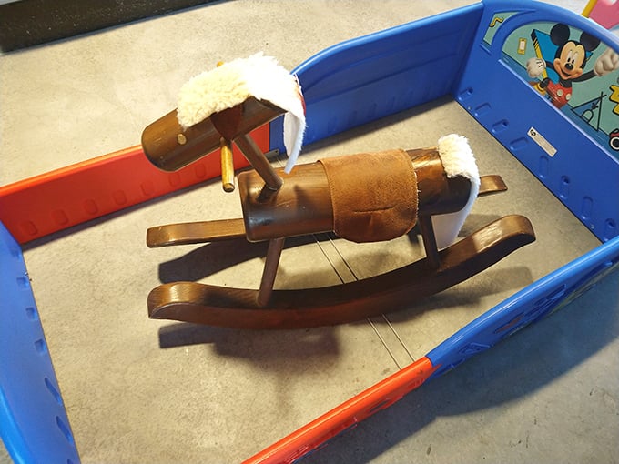 A tiny wooden rocking horse that's ready to gallop into a child's imagination or serve as the perfect nostalgic accent in a nursery.