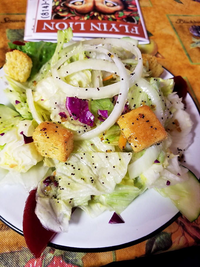 A fresh house salad with crisp vegetables and croutons, because even colonial taverns understand balance on a plate.