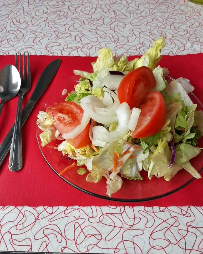 A garden on a plate&mdash;this salad offers crisp, fresh vegetables that somehow taste better under the glow of vintage diner lighting.