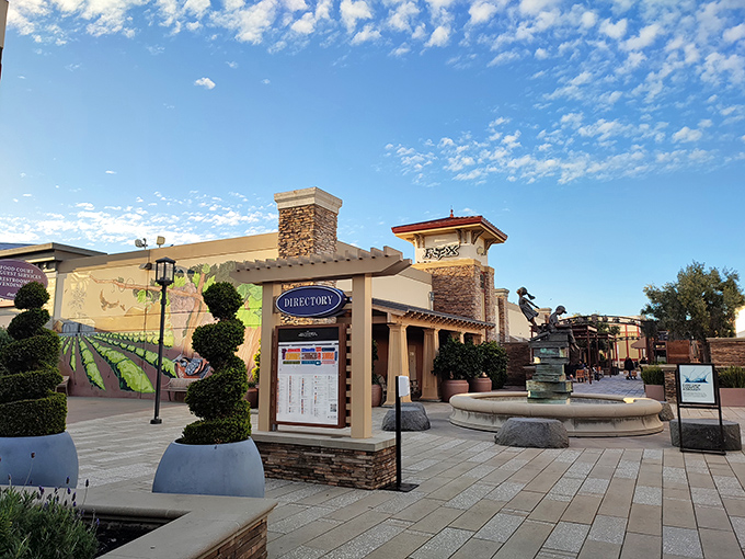 Blue skies frame the Mediterranean-inspired architecture, with directory signs standing ready to guide lost bargain hunters.