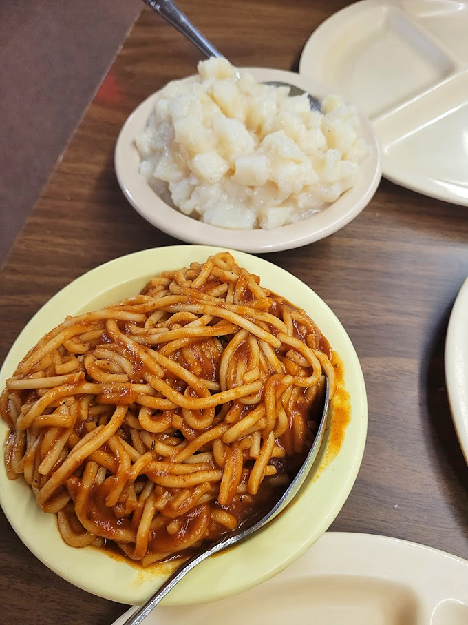 Spaghetti with meat sauce alongside potato salad – a combination that screams "Midwest" louder than a tornado siren on a clear day.