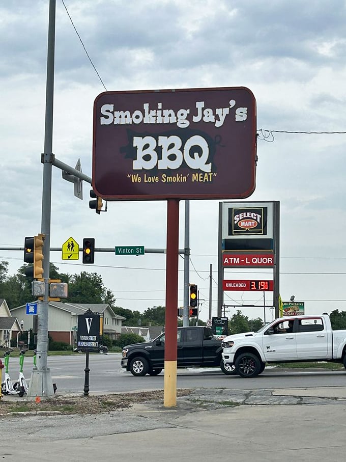 The roadside sign stands tall against Nebraska skies, a North Star for those navigating by their hunger rather than GPS.