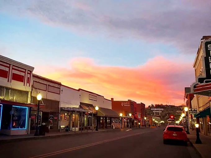Downtown Silver City at dusk transforms into a painting of warm light and long shadows against a sky on fire.