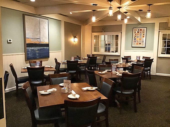 The dining room balances nautical charm with comfortable elegance. Those seafaring paintings on the wall practically whisper tales of the Atlantic.