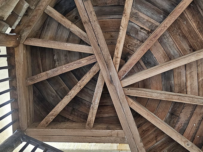 Masterful woodwork creates a geometric ceiling pattern that draws the eye upward, showcasing craftsmanship rarely seen in modern construction.