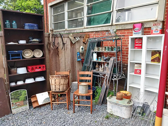 Wooden chairs, metal baskets, and vintage signs create an outdoor vignette that's part yard sale, part installation art.