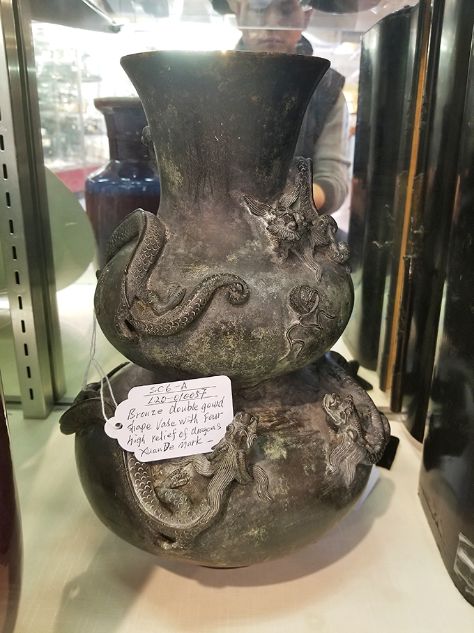 A dragon-adorned vase that's seen more dynasties than a history textbook. Perfect for holding flowers or intimidating your houseguests.