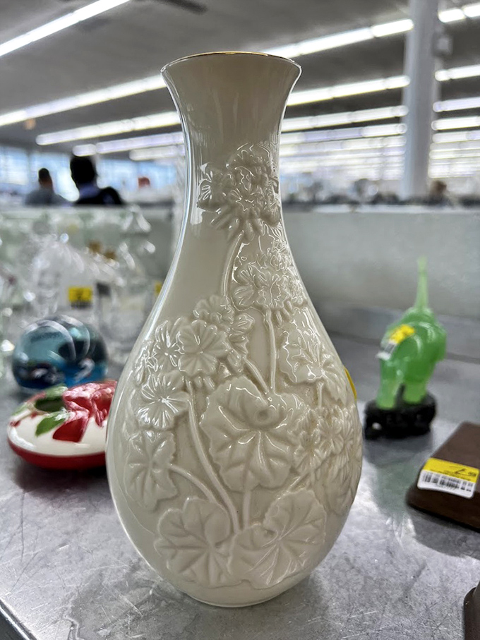 Elegant white vase with embossed flowers – proof that sometimes the classiest home decor items are hiding between someone else's castoffs.