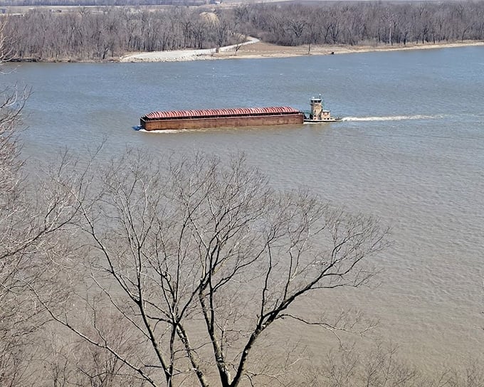 Even river barges still navigate the mighty Mississippi below, a scene Twain himself would recognize from his steamboat piloting days.
