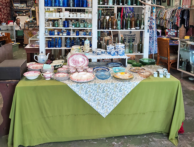 A tablecloth of memories. Each plate and teacup survived decades of family gatherings before landing in this colorful display.