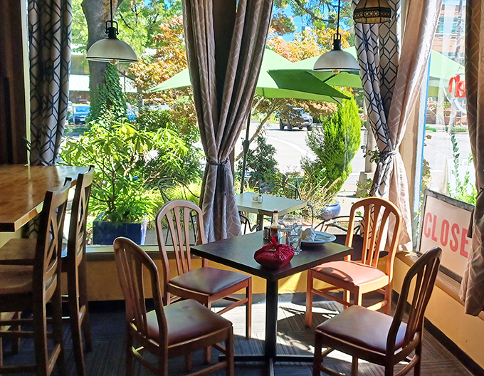 Window-side dining where Portland's greenery becomes the perfect backdrop for your morning coffee ritual and people-watching session.
