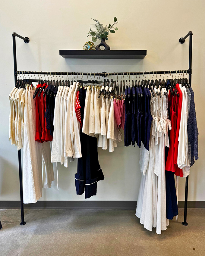 The minimalist clothing display that whispers "capsule wardrobe" while showcasing the perfect blend of neutrals with pops of patriotic color.