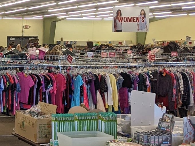 The women's section stretches like a textile rainbow, each hanger holding possibilities for reinvention and style.