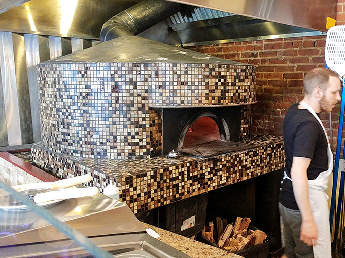 The mosaic-tiled wood-fired oven &ndash; the beating heart of Mercurio's where dough transforms into pizza magic at 800 degrees of delicious possibility.