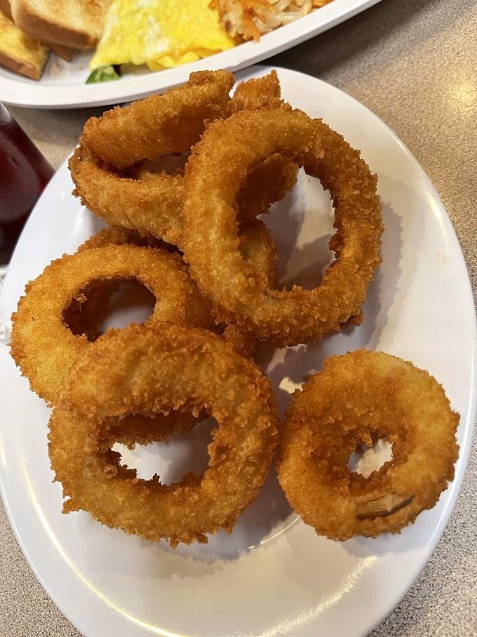 Golden breaded onion rings prove that breakfast sides can venture into unexpected territory, and nobody's complaining about the delicious detour.