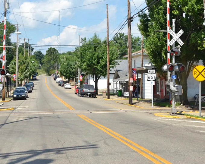 Railroad crossing signals mark Baltic's quiet main street. In small-town Ohio, even waiting for a train becomes a moment of reflection.