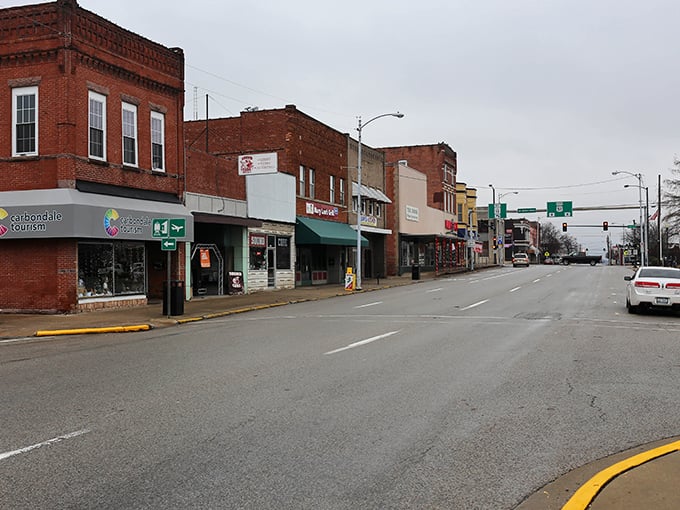 Carbondale's brick buildings stand as testaments to enduring craftsmanship. The street scene captures the perfect blend of college-town energy and small-city charm.