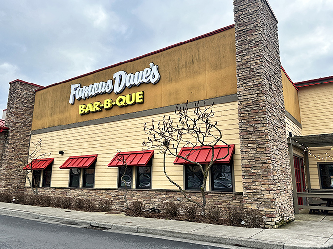 Famous Dave's brings cabin-inspired comfort to Portland's barbecue scene. Those stone columns frame a temple of smoked delights.