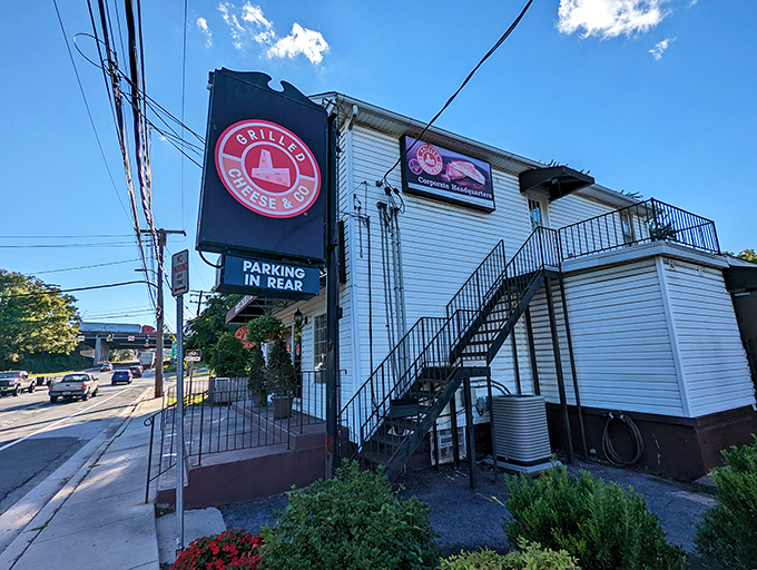 Grilled Cheese & Co.'s charming white building with its distinctive sign. Where childhood comfort food gets its grown-up glow-up.