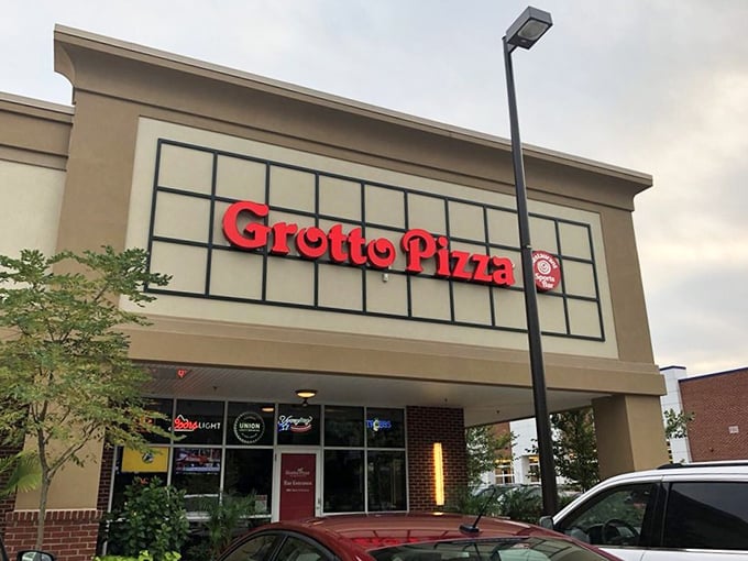 Grotto Pizza's sleek exterior hints at the modern pizza artistry happening inside those gleaming glass doors. 