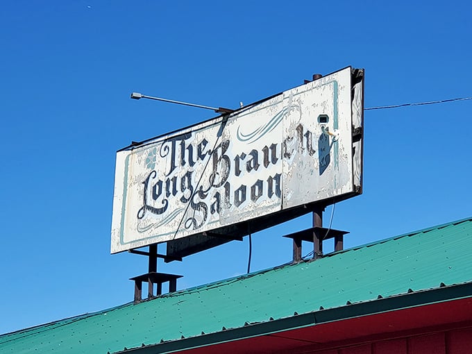 The weathered sign hints at old-west charm, but the packed parking lot tells the real story &ndash; these burgers are legendary.