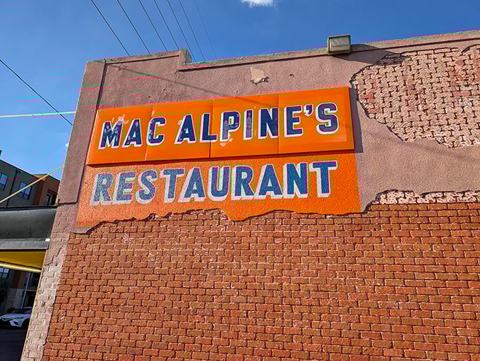 MacAlpine's bold orange sign against classic brick hints at the vibrant flavors waiting inside this Phoenix institution.