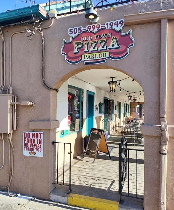 Step through this archway into Old Town Pizza Parlor's courtyard and prepare for a slice of Albuquerque history.