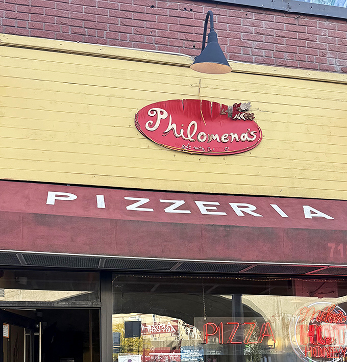 Philomena's Pizza: That cheerful yellow facade topped with brick - like sunshine and stability in pizza form.