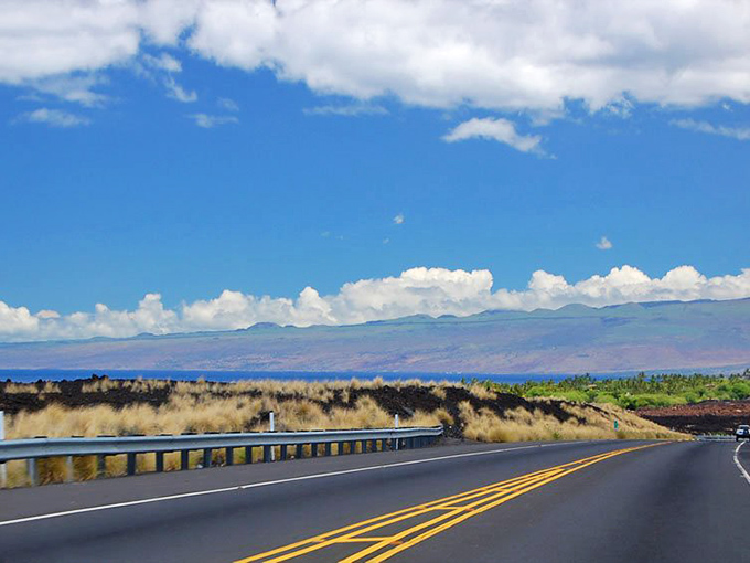 Where lava meets highway meets ocean! Queen Ka'ahumanu's coastal route serves up a geological triple-decker sandwich with extra blue sky on top.