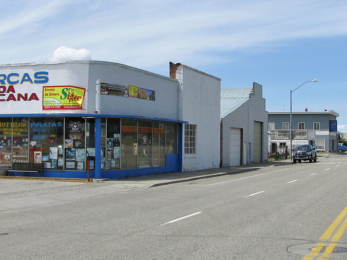 That blue storefront adds cheerful color to streets where businesses still remember customers' names and coffee preferences.