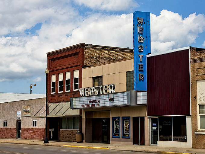 The historic Webster Theater stands proudly on Main Street, its vintage blue sign a beacon of small-town entertainment that won't break your budget.