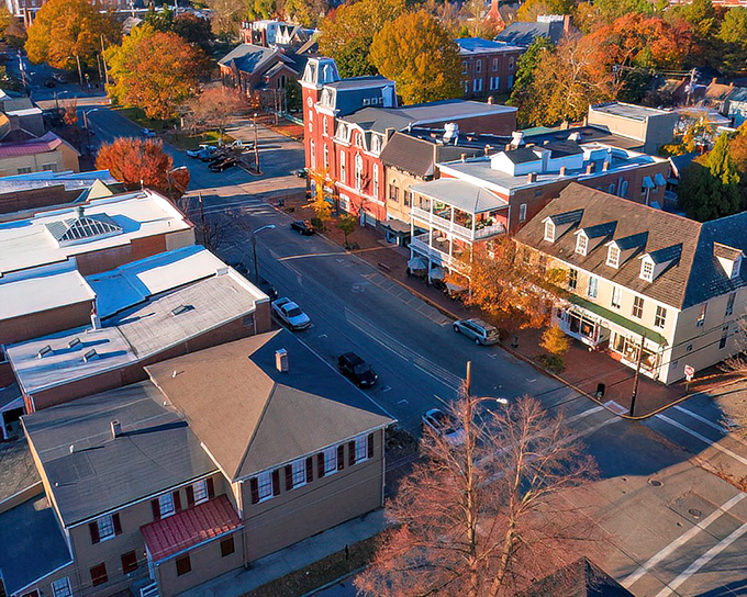 Aerial view of Denton showcases a town where autumn paints the trees in colors more vibrant than a Florida retiree's wardrobe.