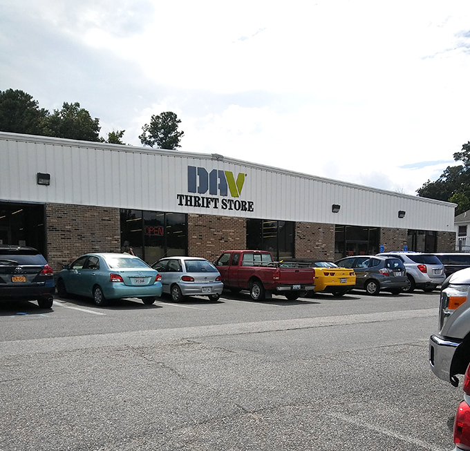 Colorful cars, colorful finds! The DAV Thrift Store's long, inviting facade promises treasures inside that match the variety in its parking lot.
