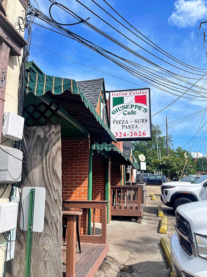 Those green awnings and brick facade hide a pizza institution that feels straight out of Little Italy.
